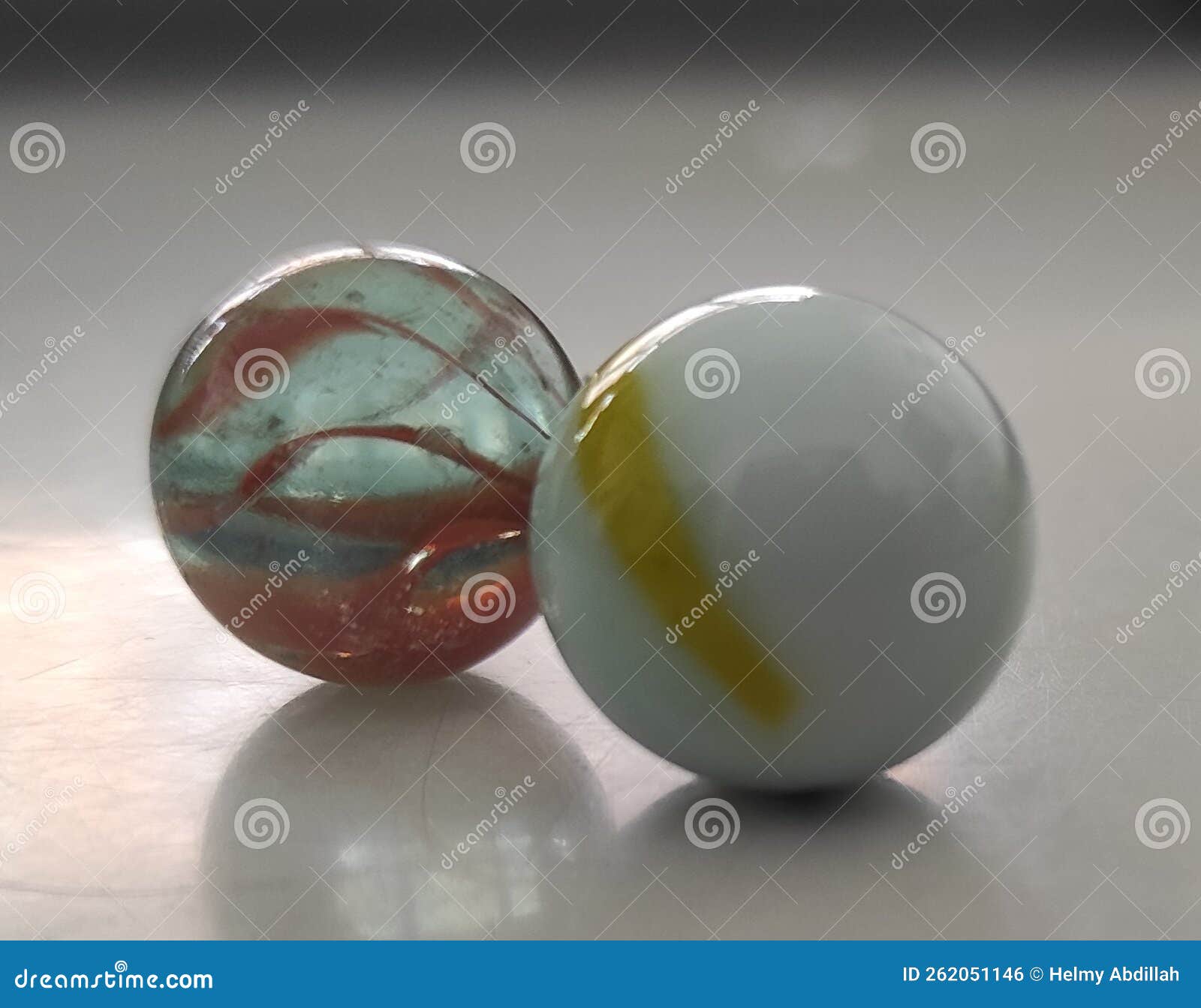 Two marbles on the floor stock photo. Image of bead - 262051146