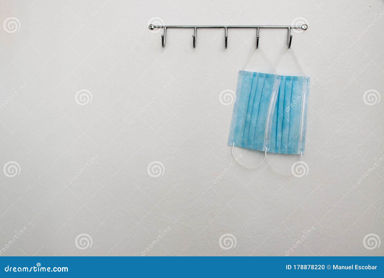 Two Masks Hanging from a Coat Rack on a White Background Stock Photo ...