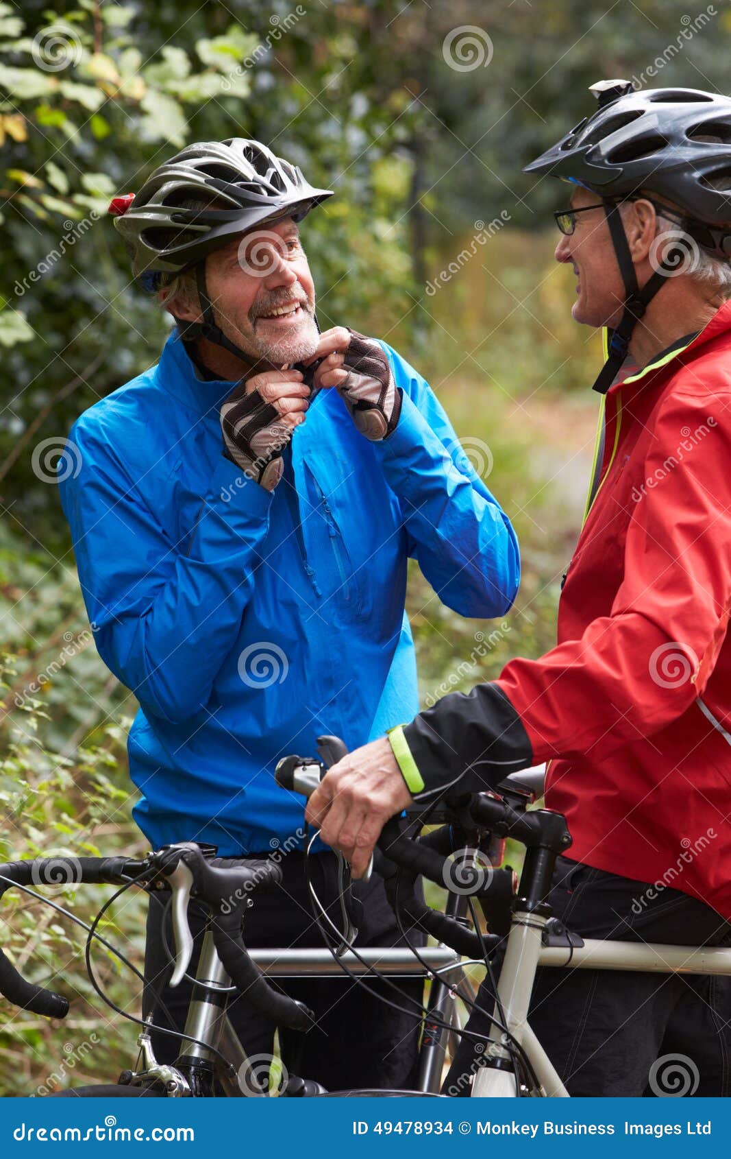 Two Mature Male Cyclists Riding Bikes Along Path Stock Photo - Image of ...