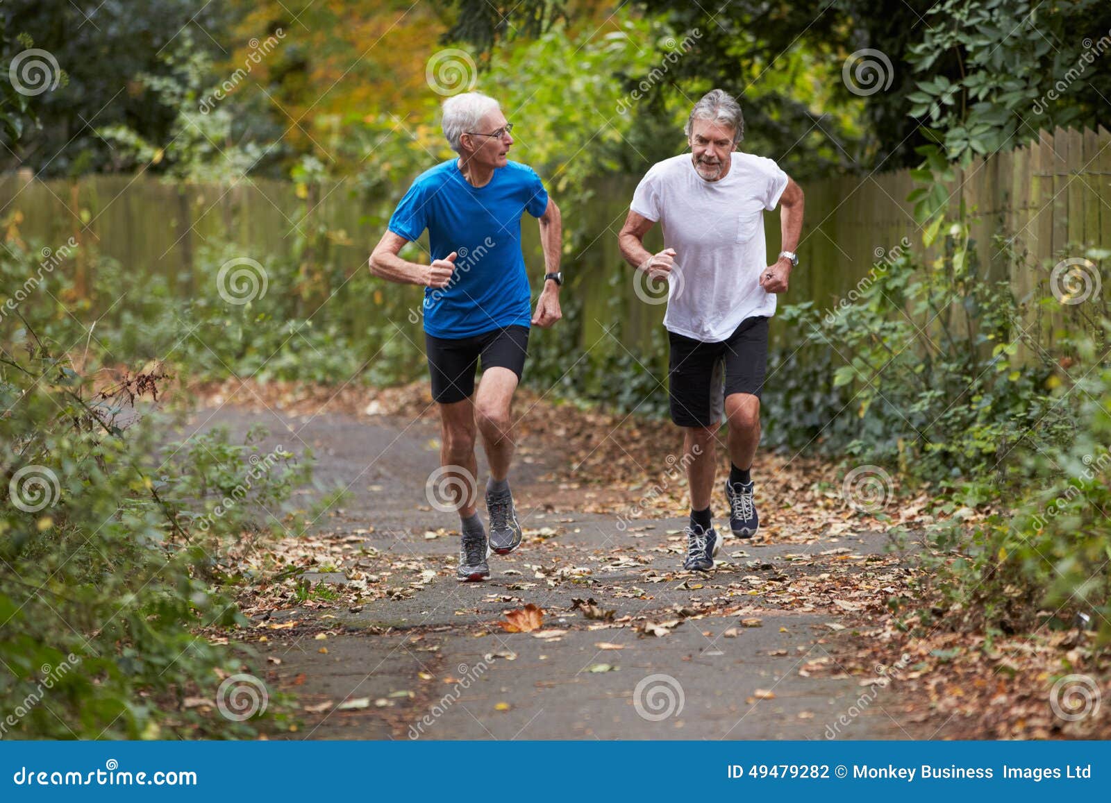 Two Mature Male Joggers Running Along Path Stock Photo - Image of ...