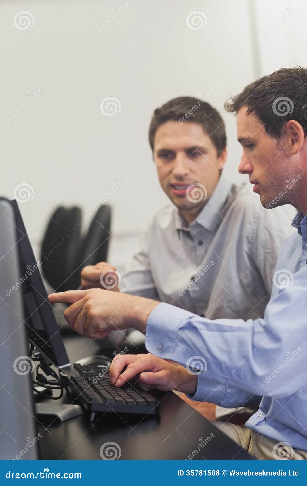 Two Mature Men Talking while Sitting in Front of Computer Stock Photo ...