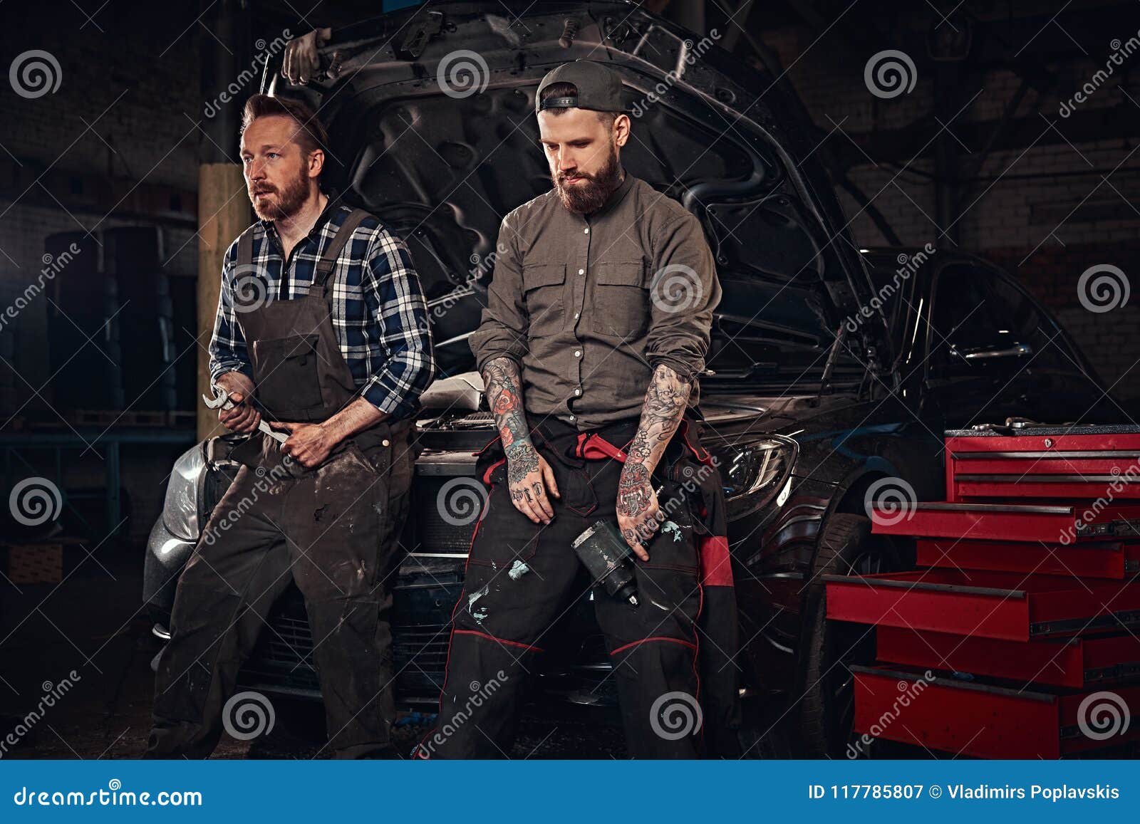 Two Mechanic Sit on a Broken Car, Rest after a Hard Day`s Work in a ...