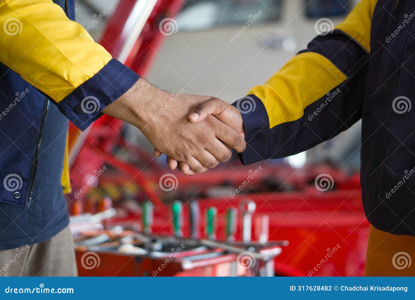 Two Mechanic in Work Uniform Engaged in a Handshake. Atmosphere in ...
