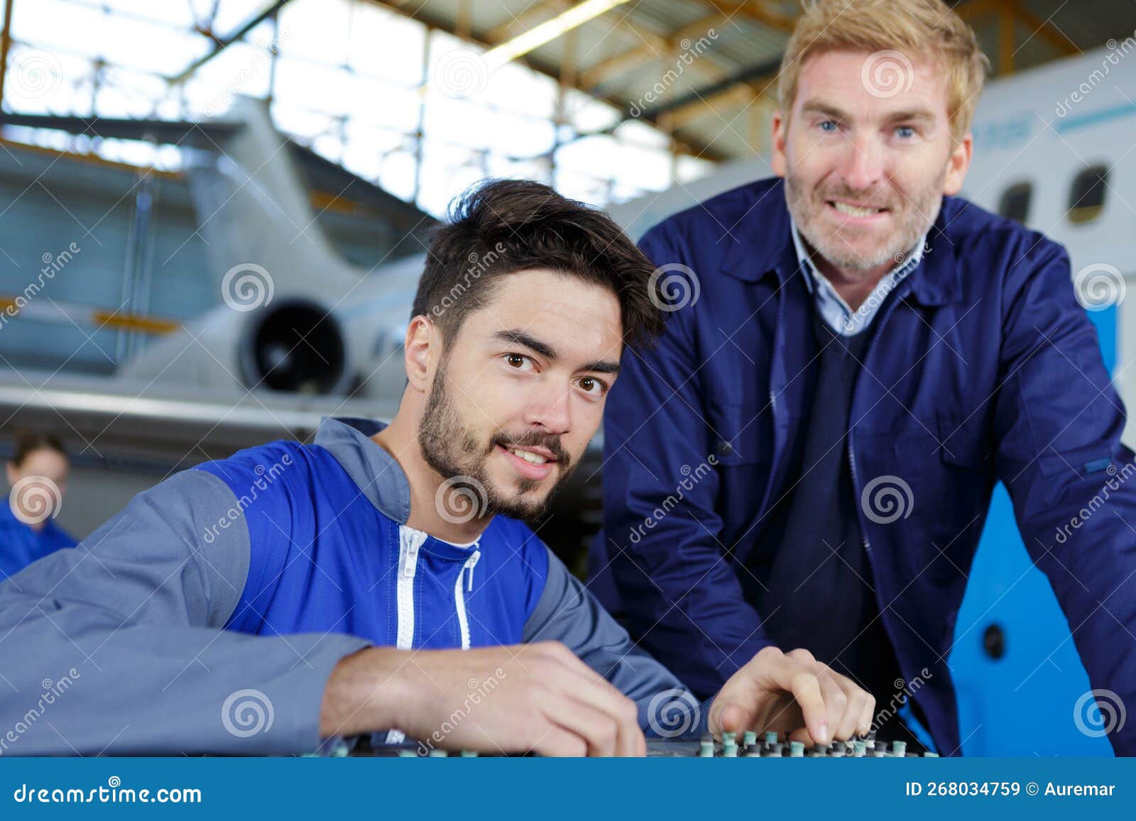Two mechanics in hangar stock image. Image of cooperation - 268034759