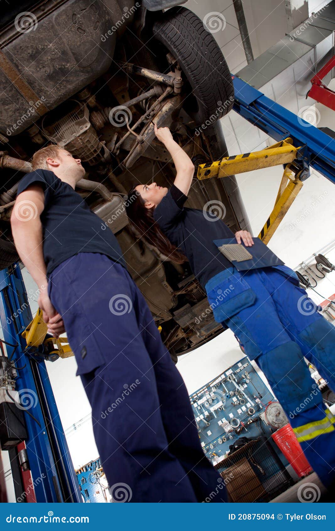 Two Mechanics Looking at Car Stock Photo - Image of lift, caucasian ...