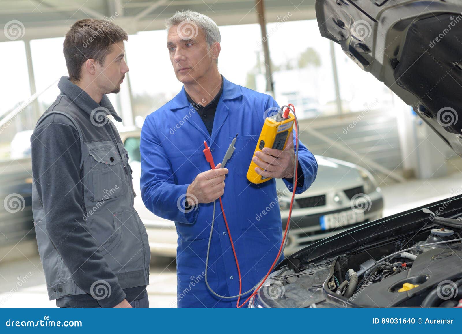 Two Mechanics Looking at and Working on Car Stock Photo - Image of ...