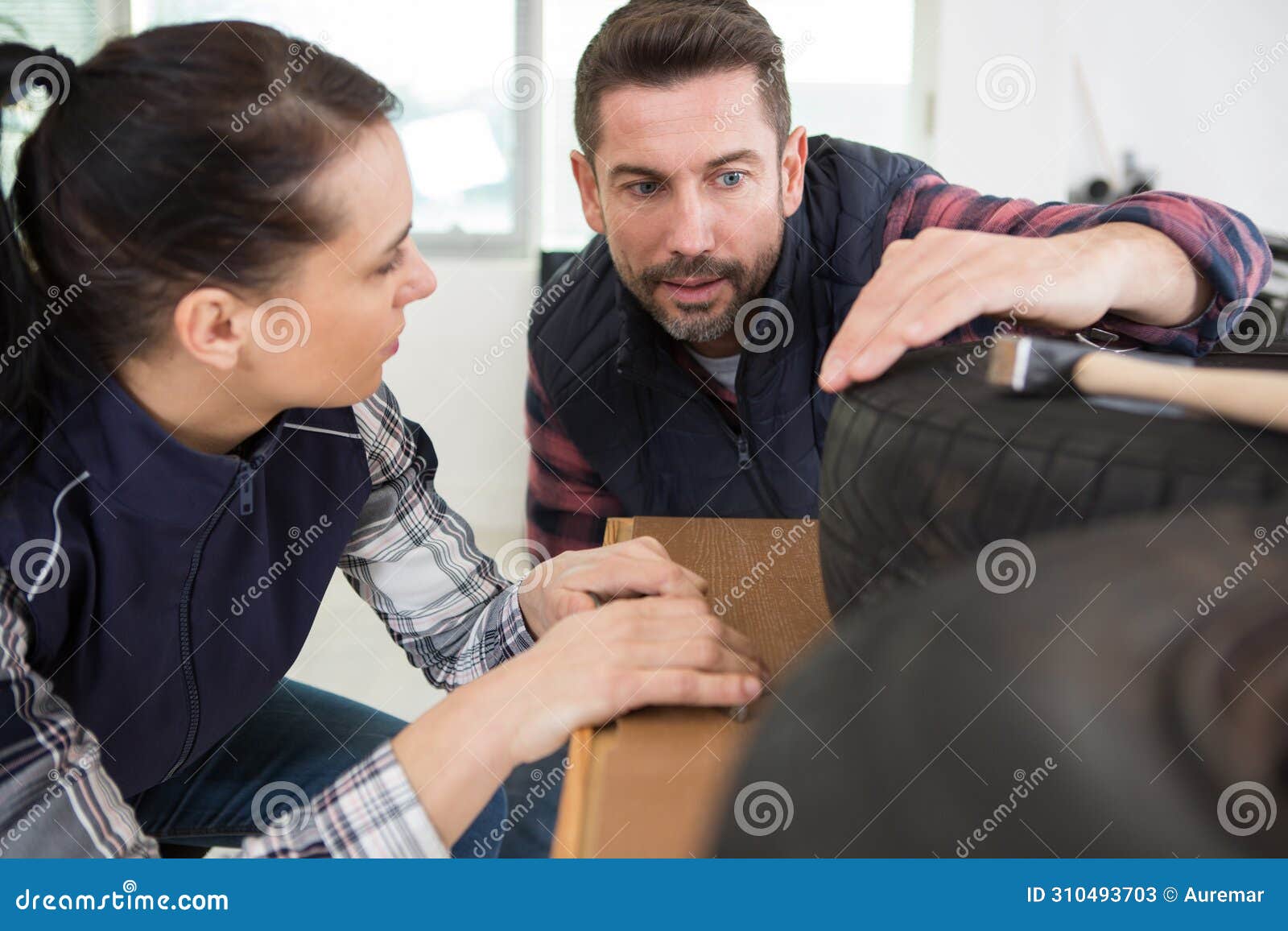 Two Mechanics Operating Wheel Equilibrium Control at Auto-workshop ...