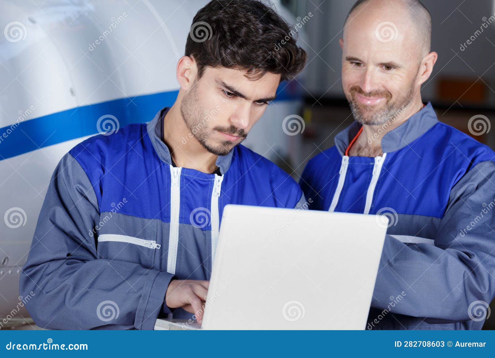 Two Mechanics Questioning Themselves about Car Part Stock Image - Image ...
