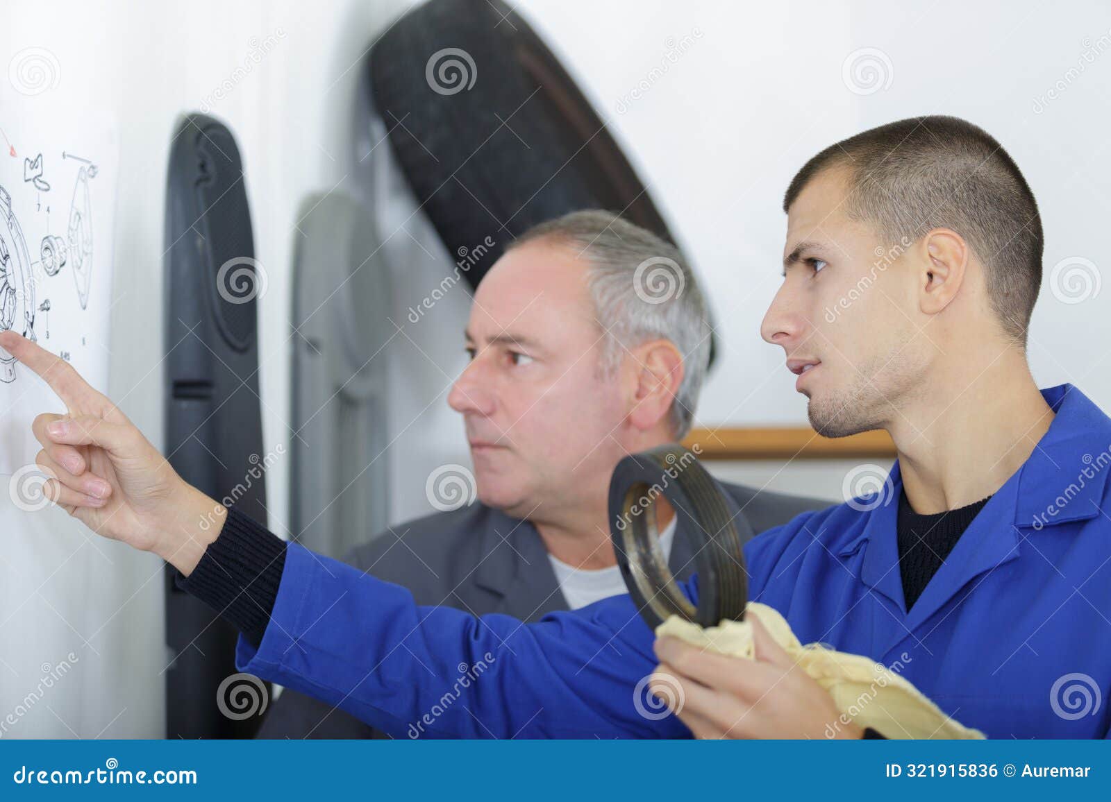 Two Mechanics Questioning Themselves about Car Part Stock Photo - Image ...