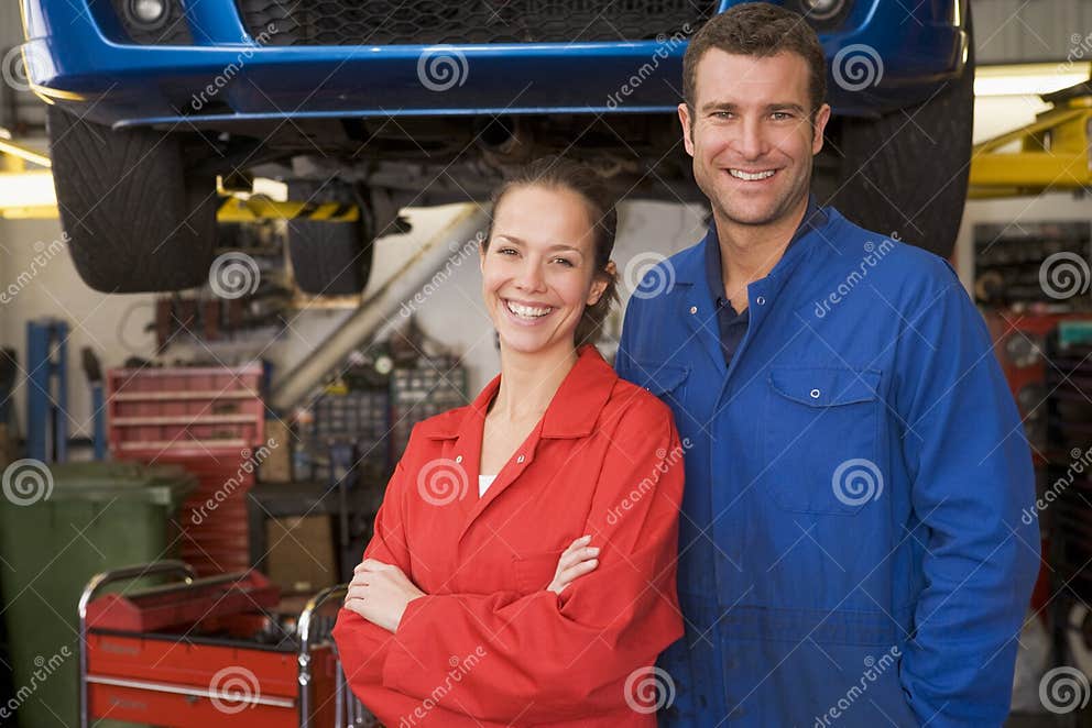 Two Mechanics Standing in Garage Smiling Stock Photo - Image of ...