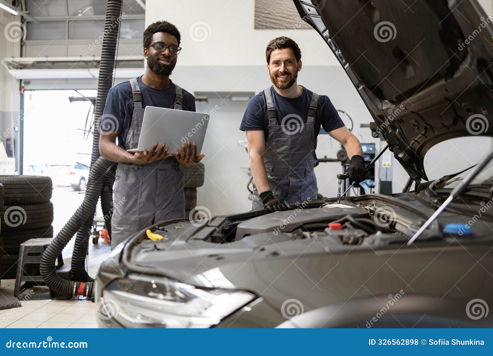 Two Mechanics Working on Car Engine in Garage Stock Photo - Image of ...