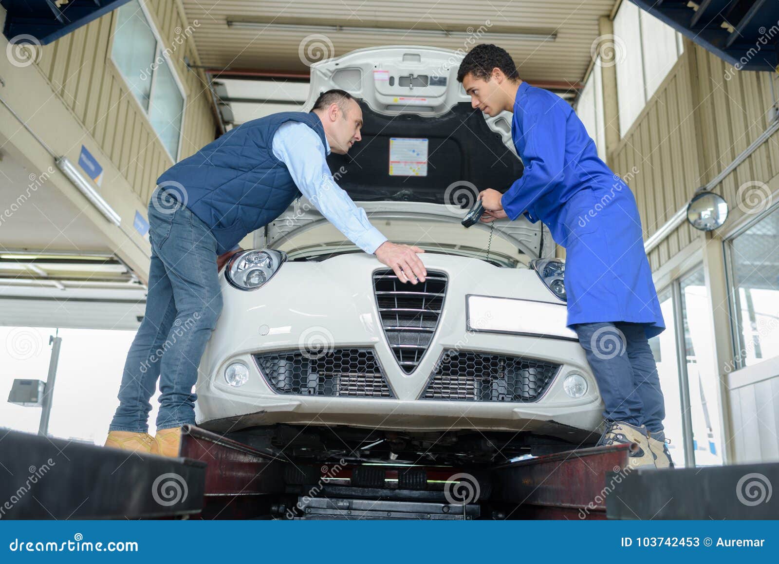Two Mechanics Working on Car Engine at Garage Stock Image - Image of ...