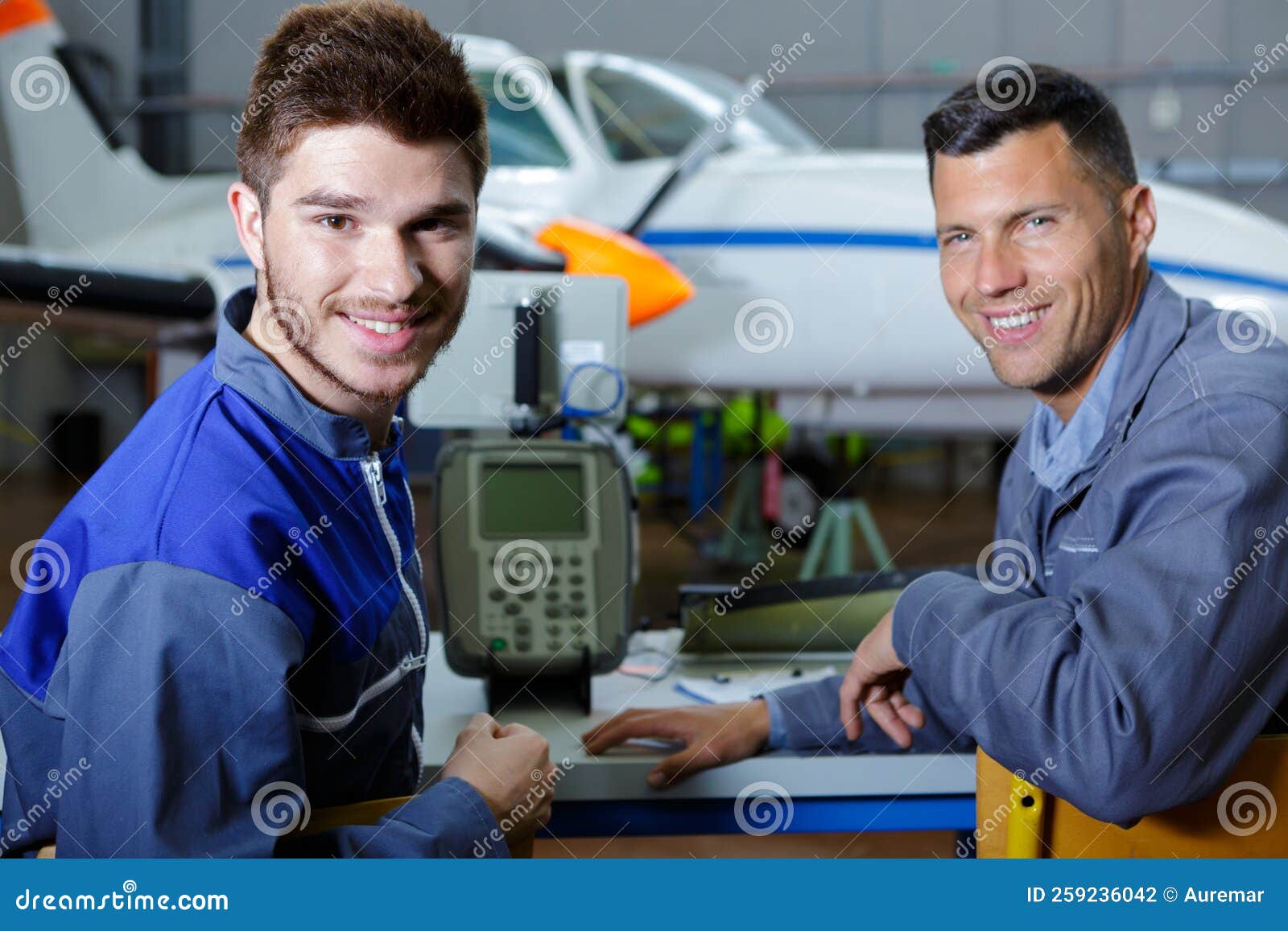 Two Mechanics Working on Aircraft Stock Photo - Image of plane ...