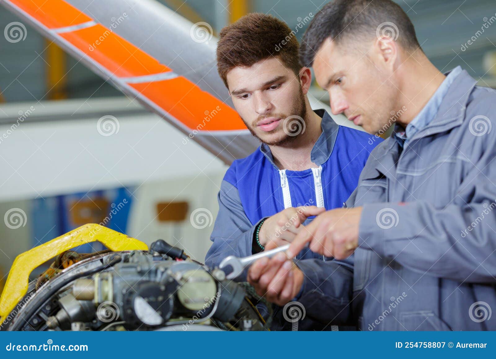 Two Mechanics Working on Aircraft in Hangar Stock Image - Image of ...