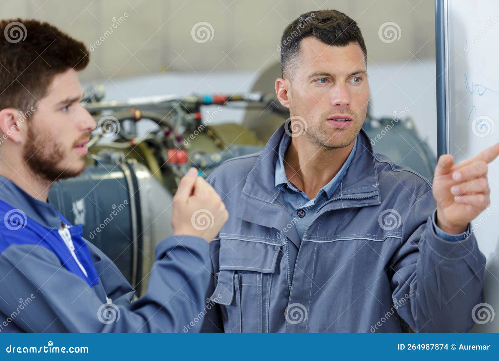 Two Mechanics Working on Aircraft in Hangar Stock Photo - Image of ...
