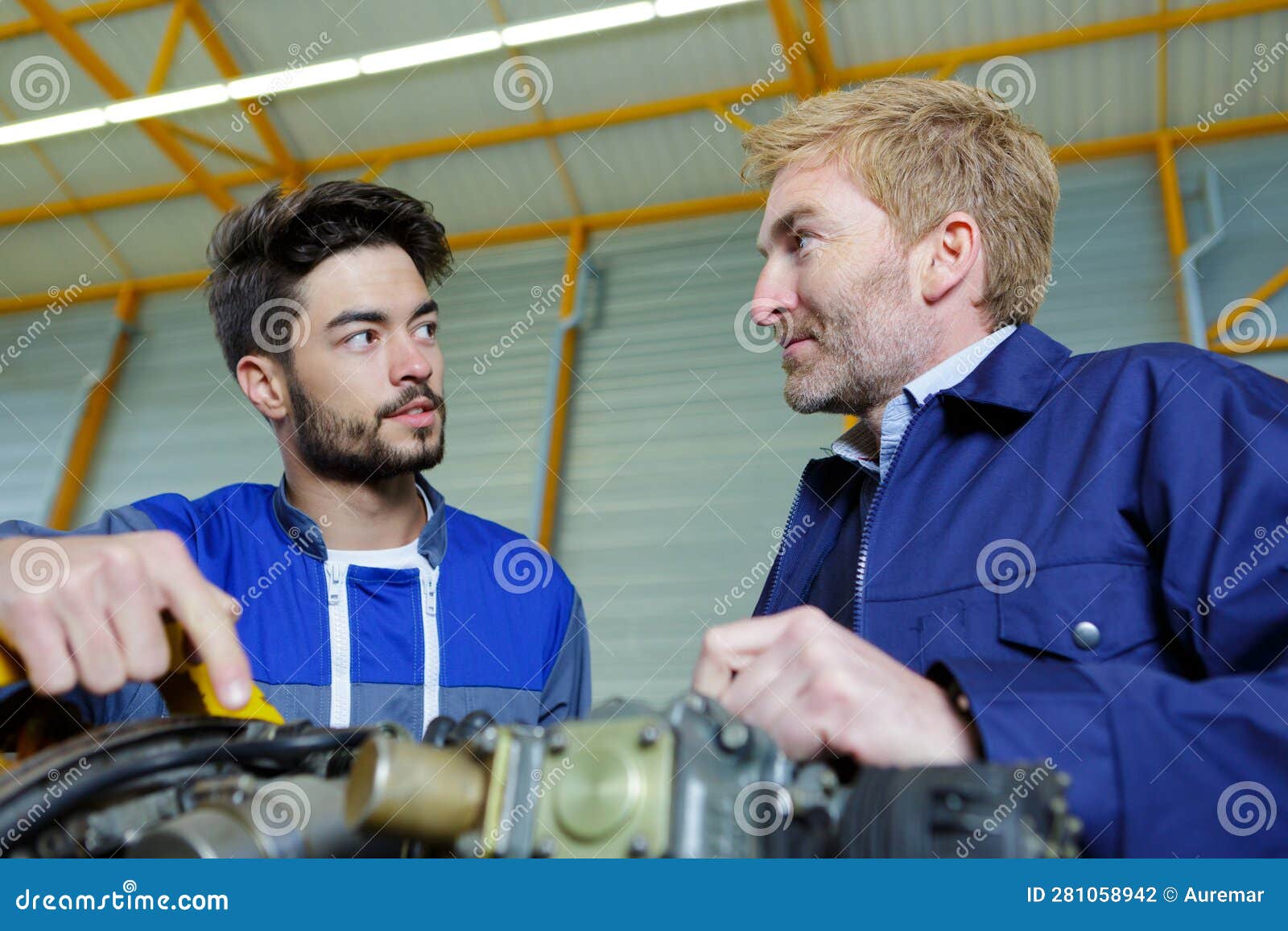 Two Mechanics Working on Aircraft in Hangar Stock Photo - Image of team ...