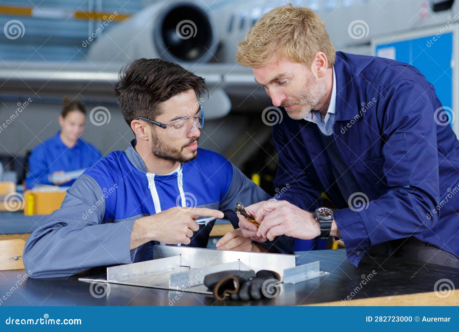Two Mechanics Working on Aircraft in Hangar Stock Photo - Image of ...