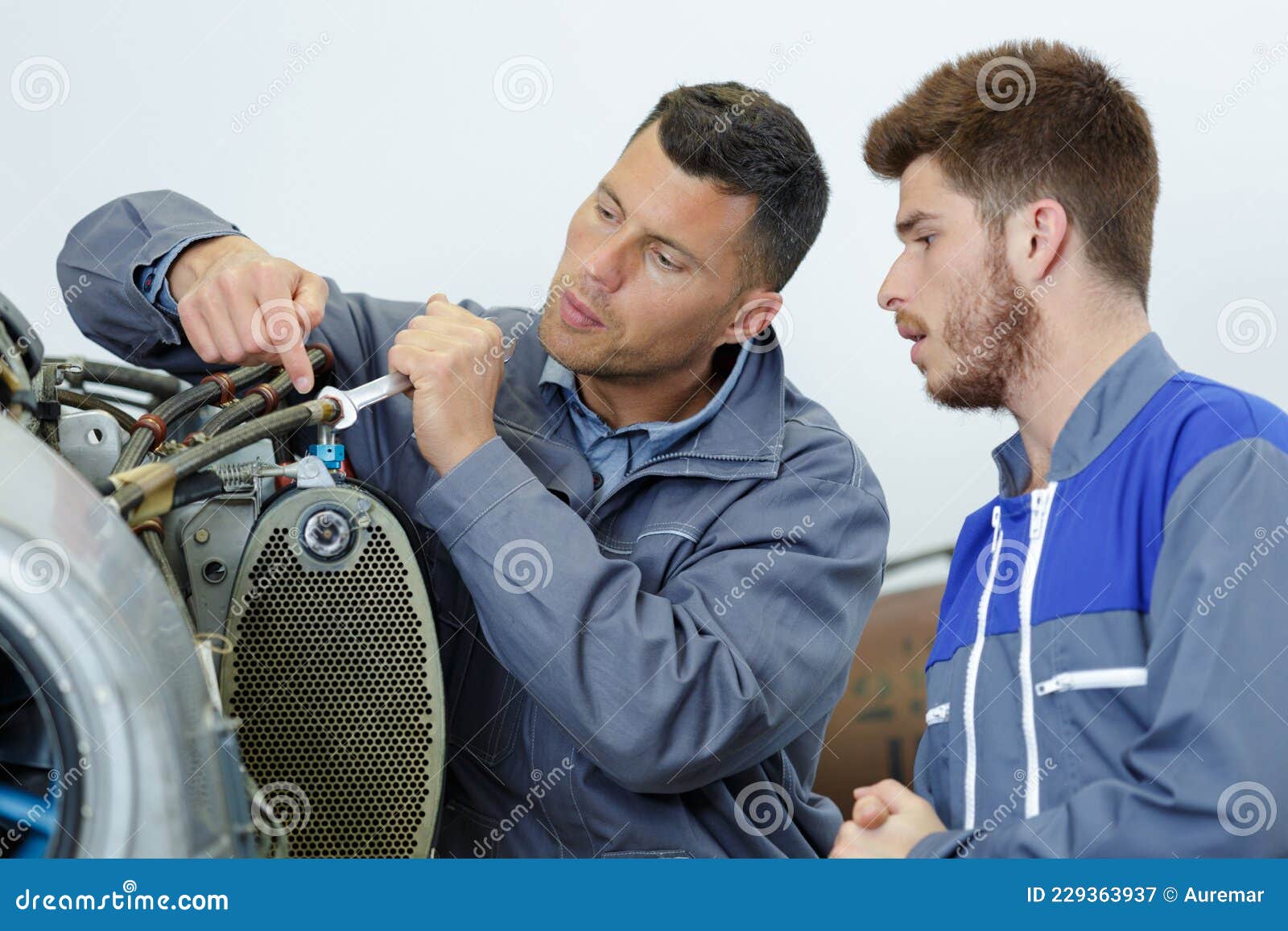 Two Mechanics Working Together Stock Image - Image of uniform, tool ...