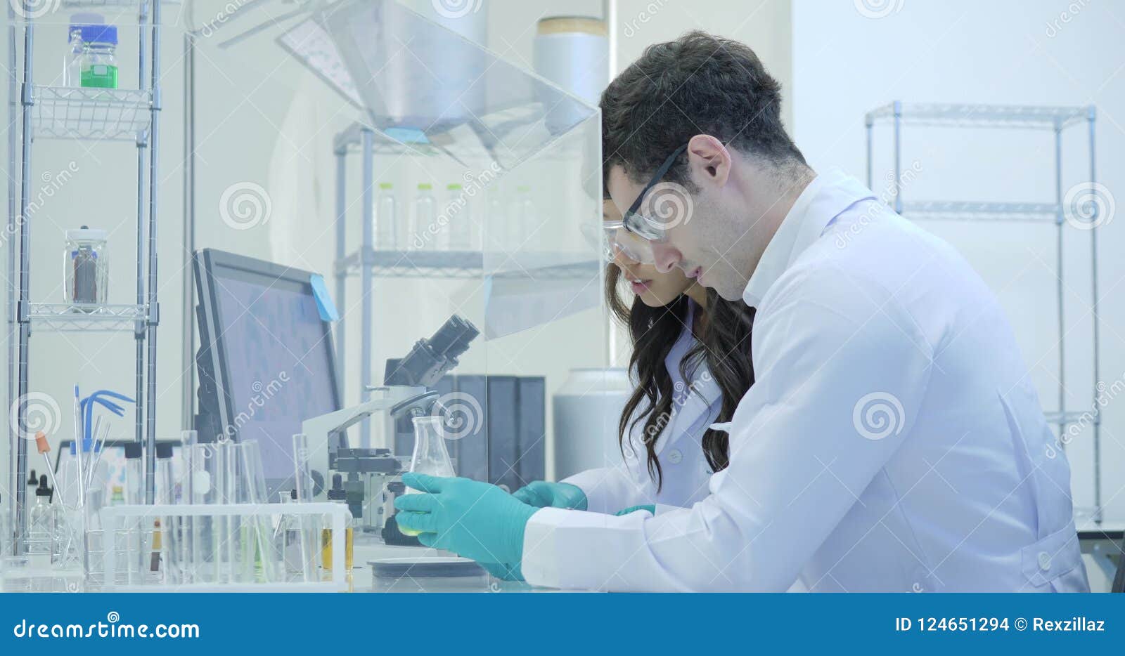 Two Medical Research Scientists Works with Samples in Isolation Box ...