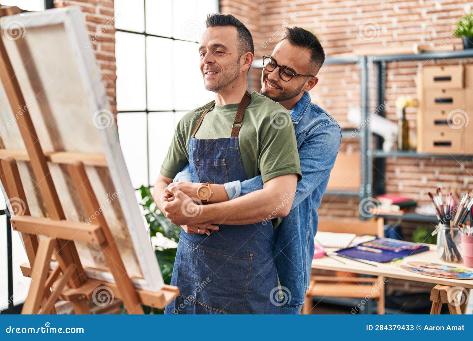 Two Men Artists Hugging Each Other Looking Draw at Art Studio Stock ...