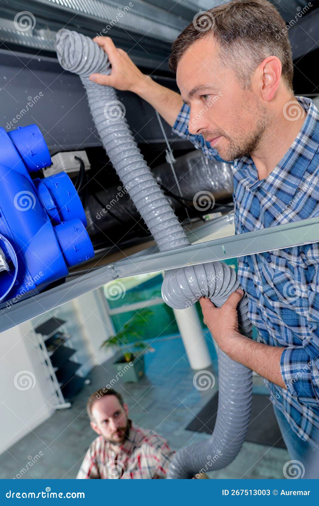 Two men assembling pipes stock image. Image of repair - 267513003