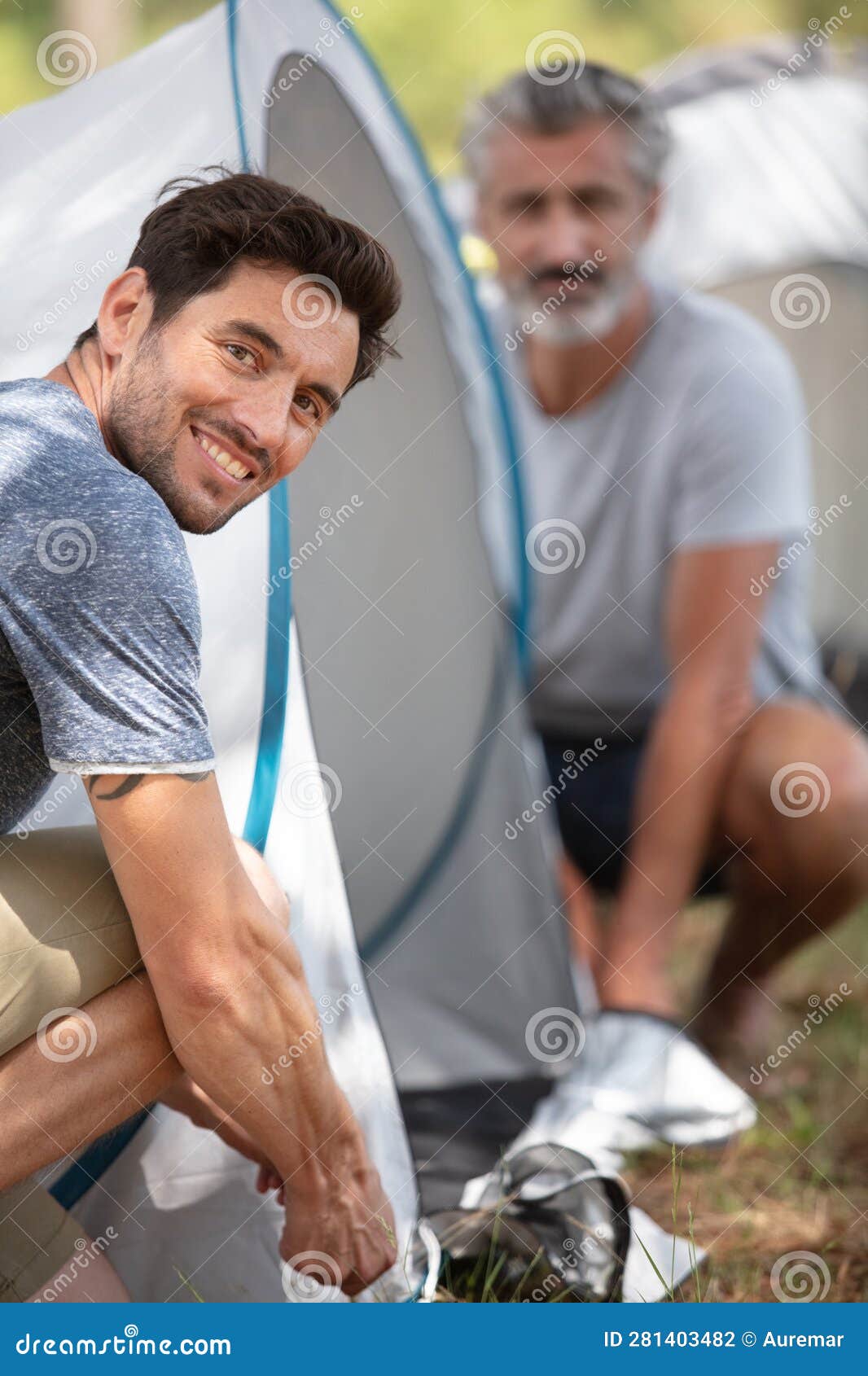 Two men assembling tent stock photo. Image of adventure - 281403482