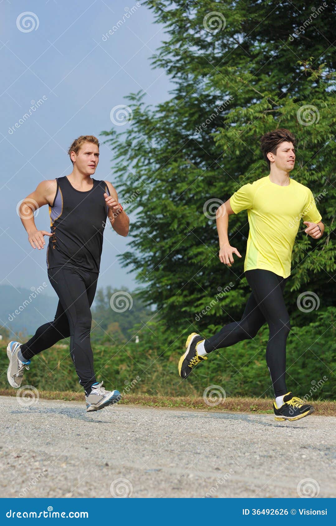 Two Men Athletes Running through Park Stock Photo - Image of blurred ...