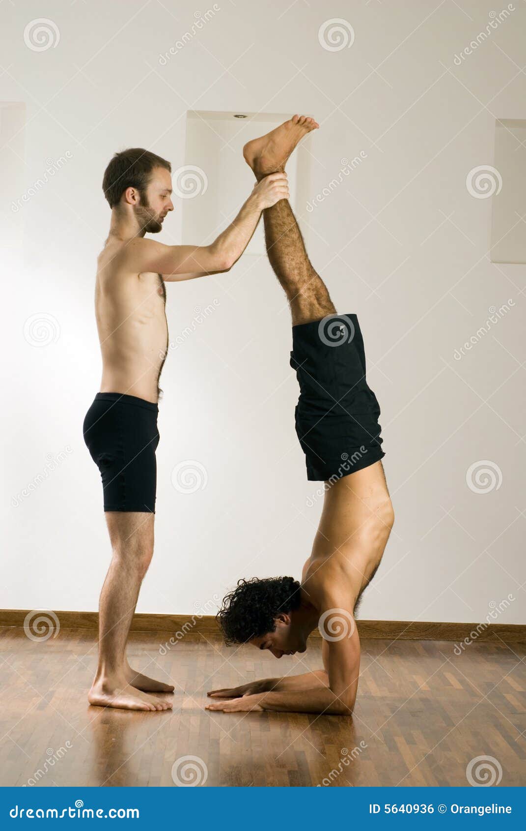 Two Men Balancing - Vertical Stock Photo - Image of floors, twenties ...