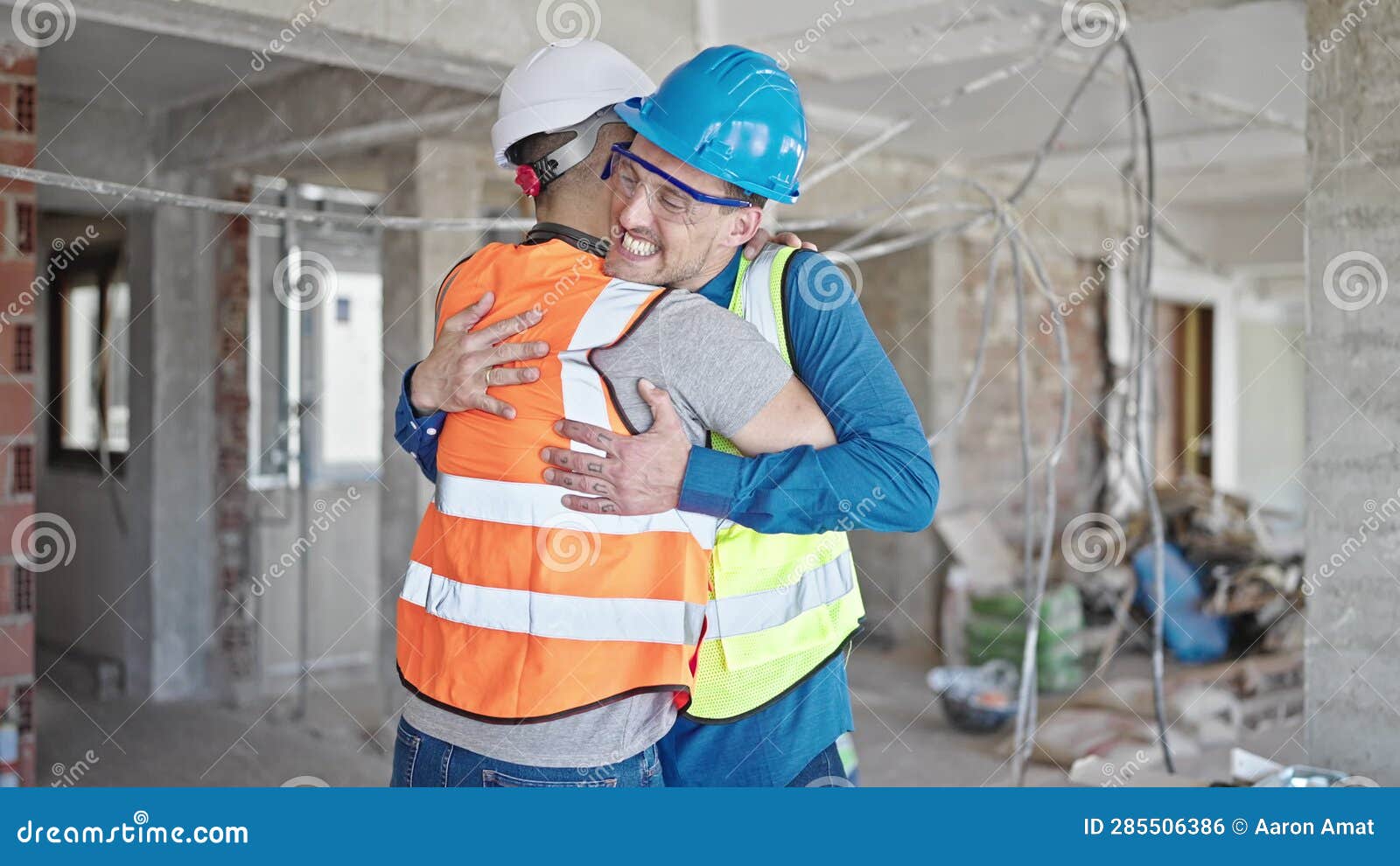 Two Men Builders High Five Hugging Each Other at Construction Site ...