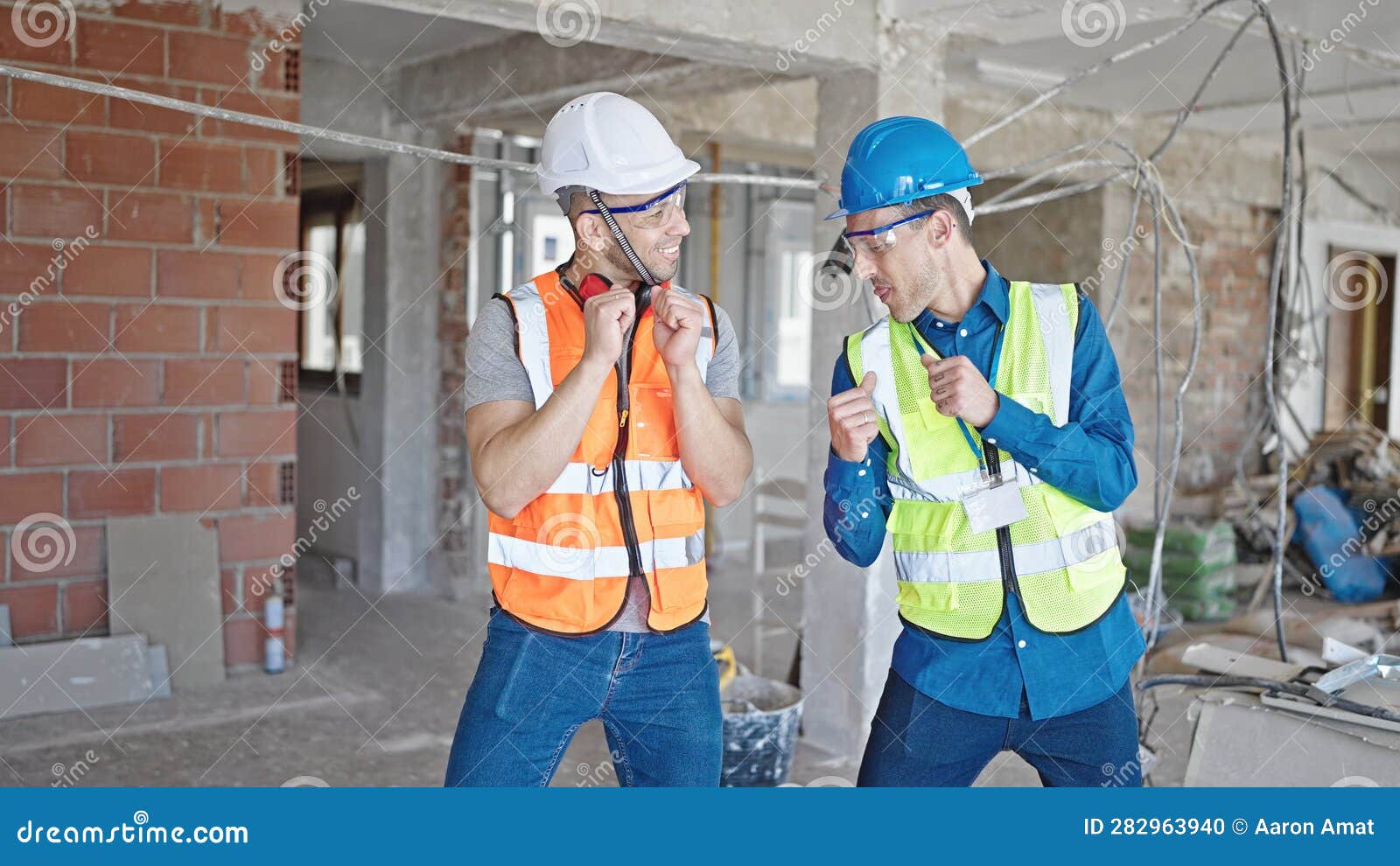Two Men Builders Smiling Confident Dancing at Construction Site Stock ...
