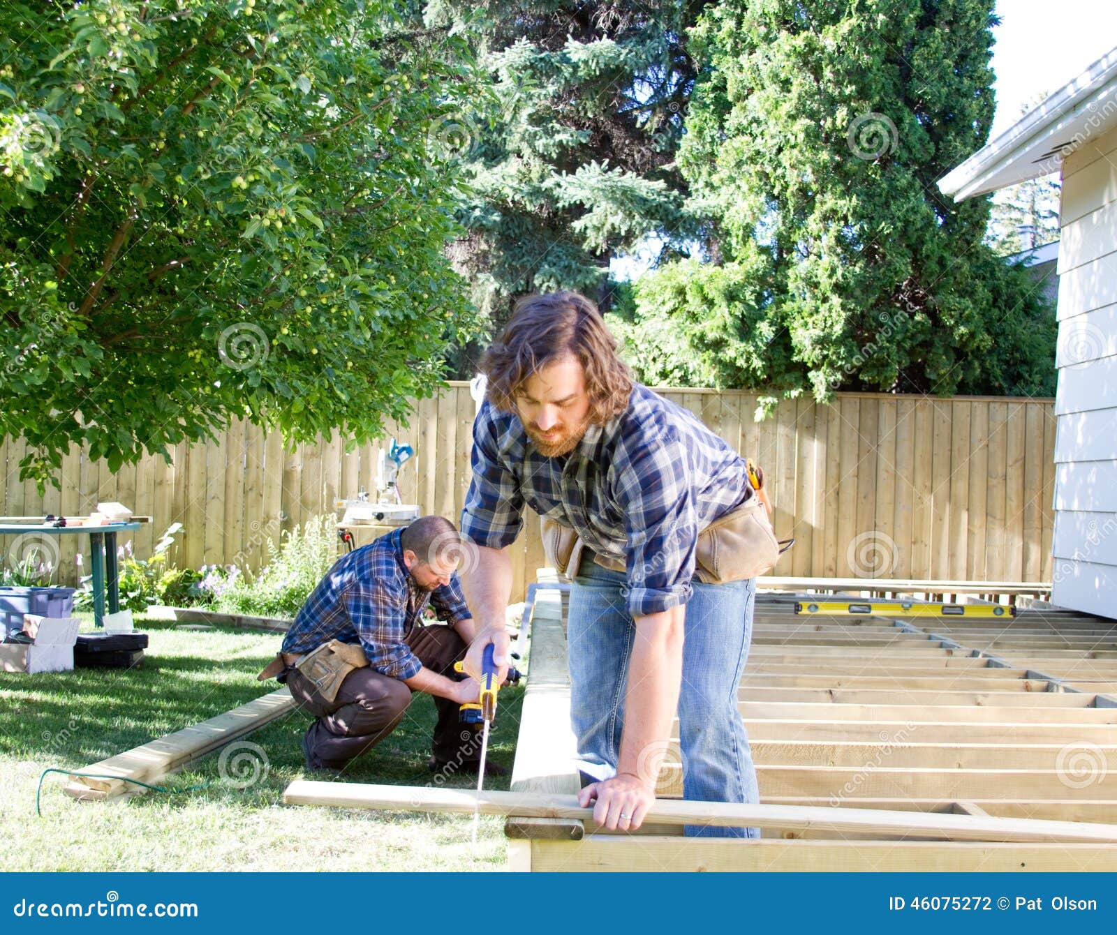 Two men building a deck stock photo. Image of wood, carpenter - 46075272