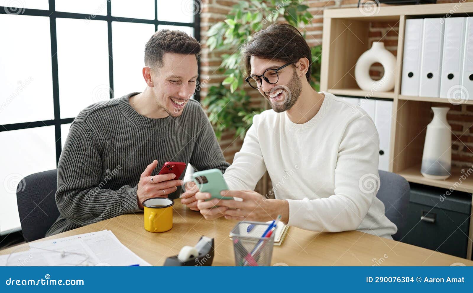 Two Men Business Partners Drinking Coffee Using Smartphones at Office ...
