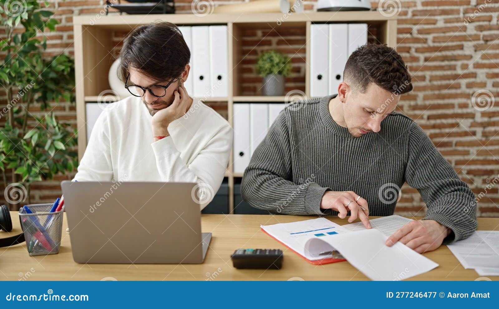 Two Men Business Partners Using Laptop Writing on Document Working at ...