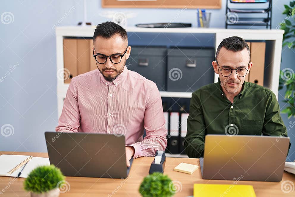 Two Men Business Workers Using Laptop Working at Office Stock Photo ...