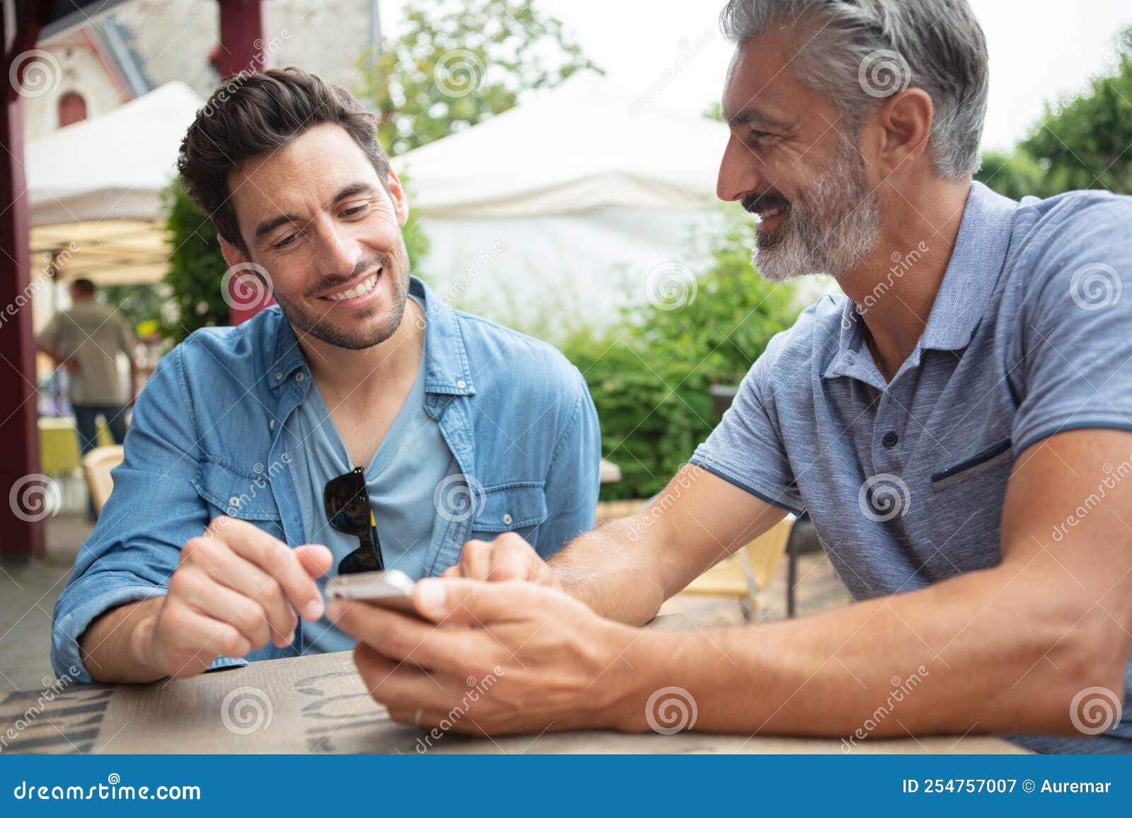 Two Men in Cafe Looking at Smartphone Stock Image - Image of person ...