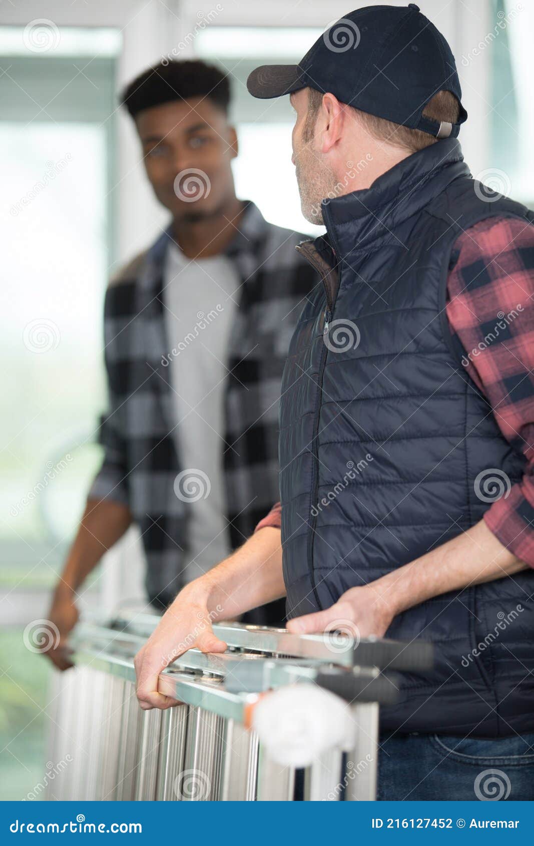 Two Men Carrying Long Ladder Stock Photo - Image of equipment ...