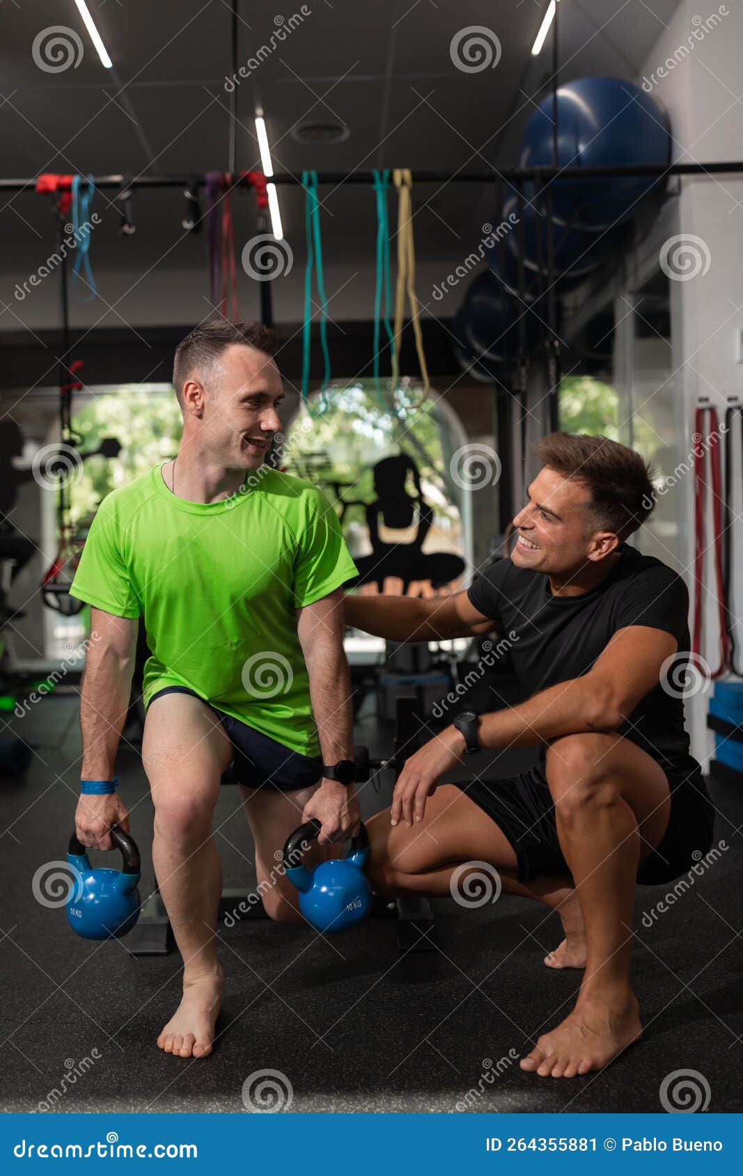 Two Men, Coach and Trainee Look at Each Other Smiling at the Gym Stock ...
