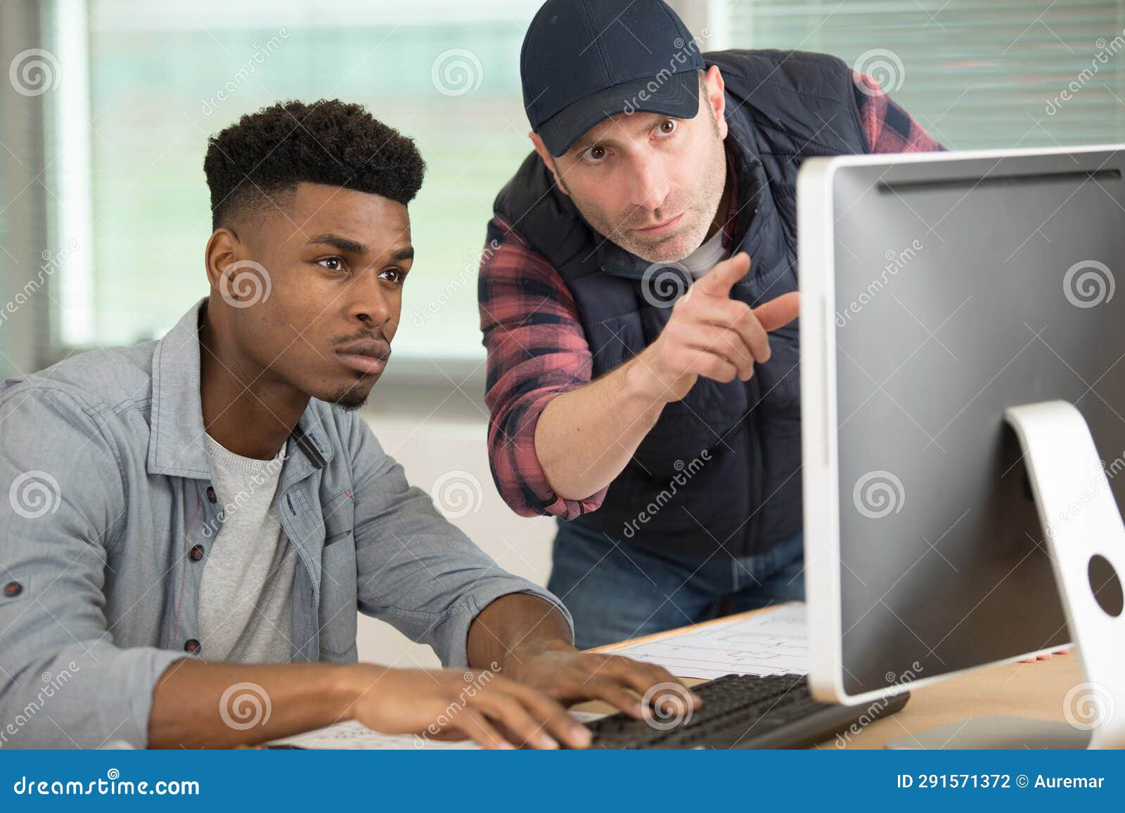 Two Men Conferring while Looking at Computer Screen Stock Photo - Image ...