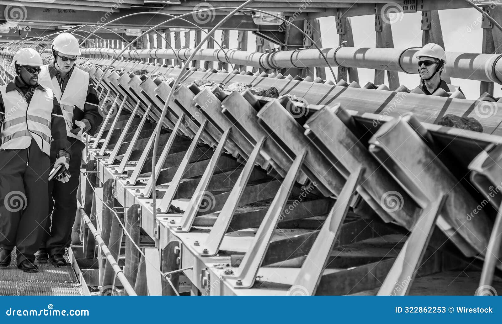Two Men in Construction Uniforms Working on Some Pipe Construction ...
