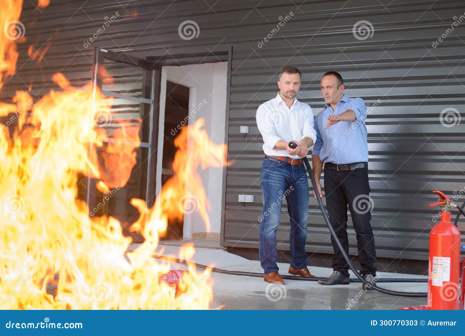 Two men controlling fire stock image. Image of vessel - 300770303