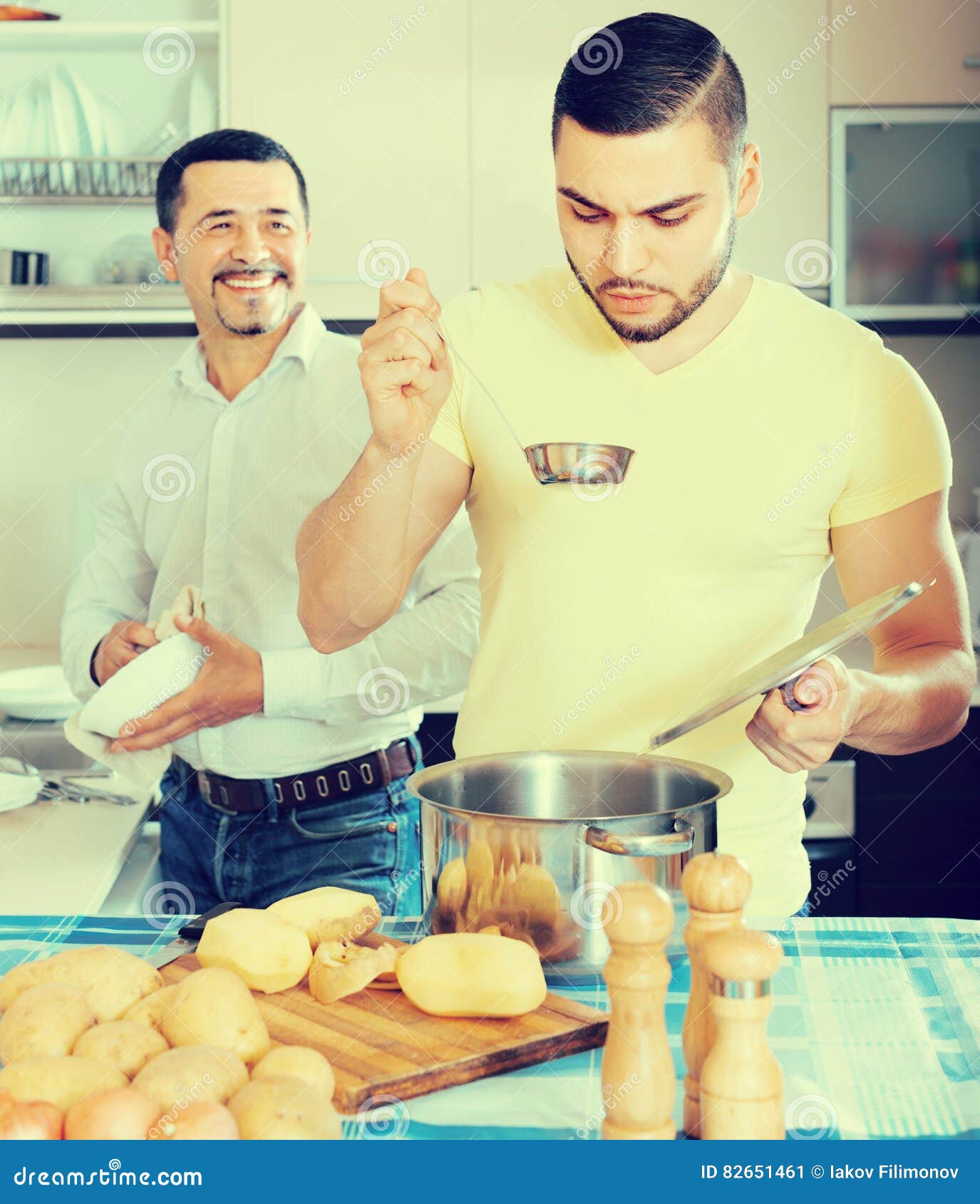 Two men cooking at home stock image. Image of prepare - 82651461