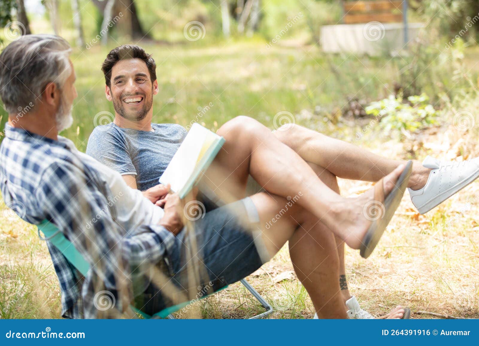Two Men in Countryside Reading and Relaxing Stock Photo - Image of ...