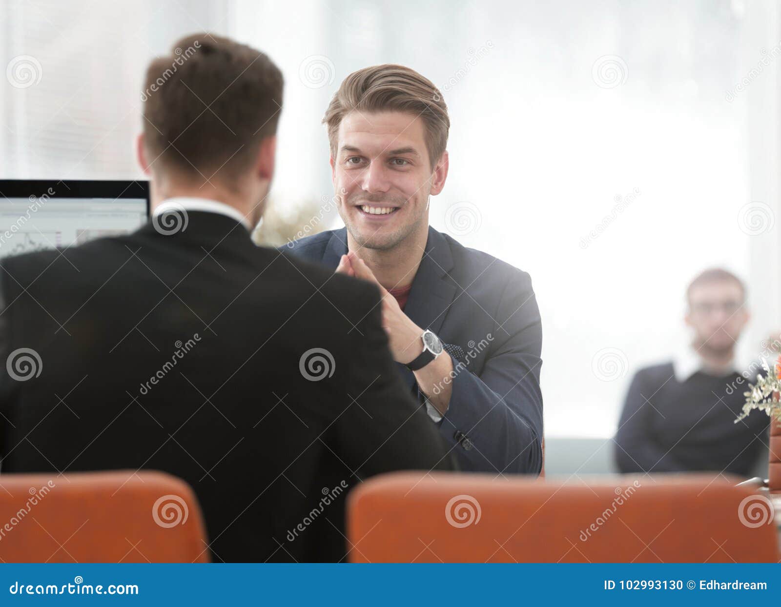 Two Men Discuss the Growth of the Company, Looking at the Rising Graph ...