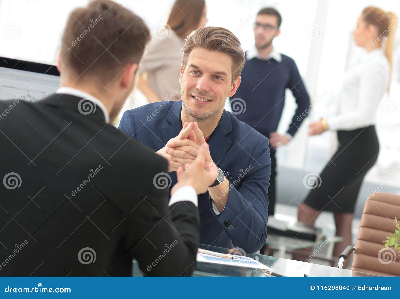 Two Men Discuss the Growth of the Company, Looking at the Rising Graph ...