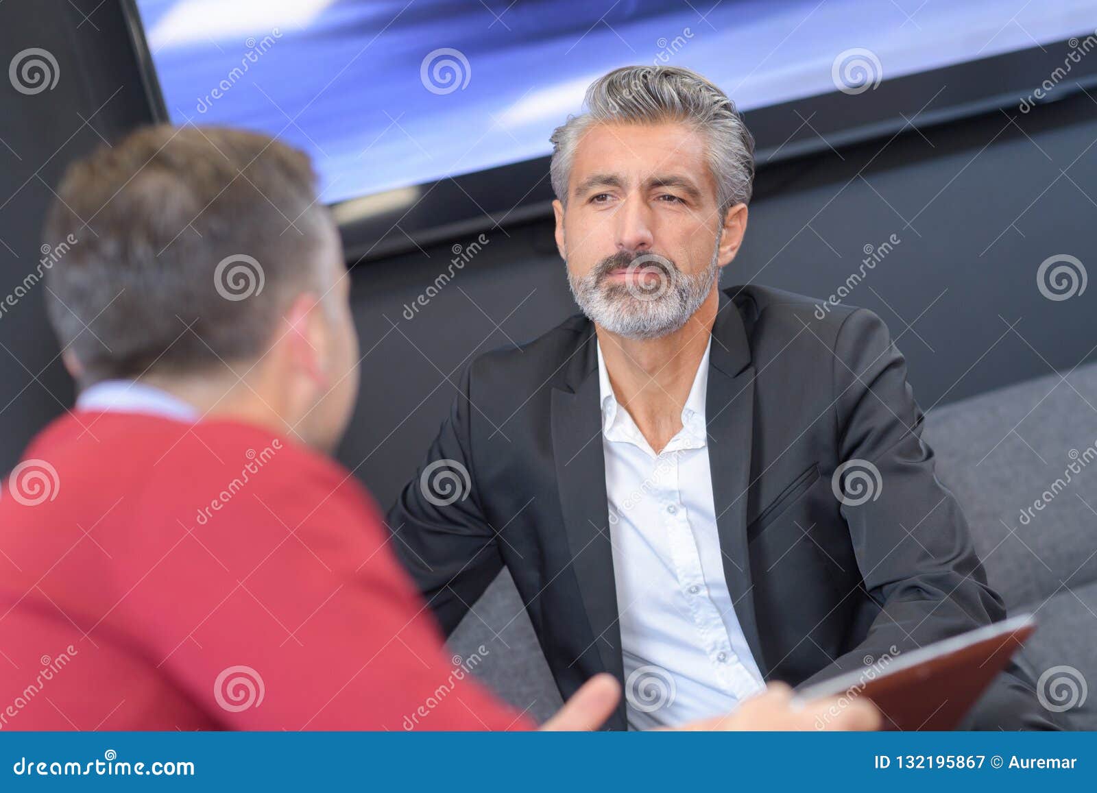 Two men in discussion stock image. Image of comfort - 132195867