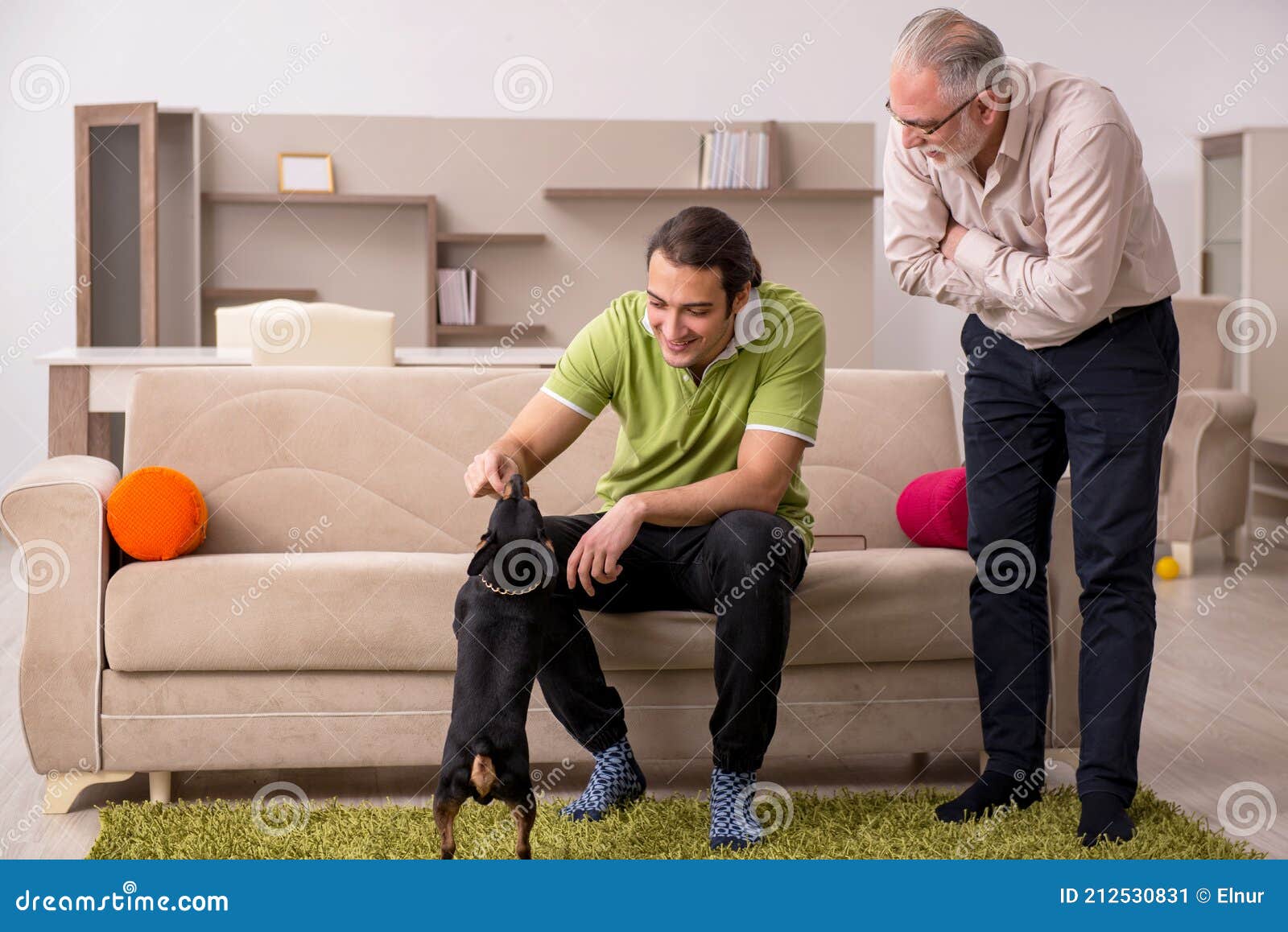 Two men with dog at home stock image. Image of funny - 212530831