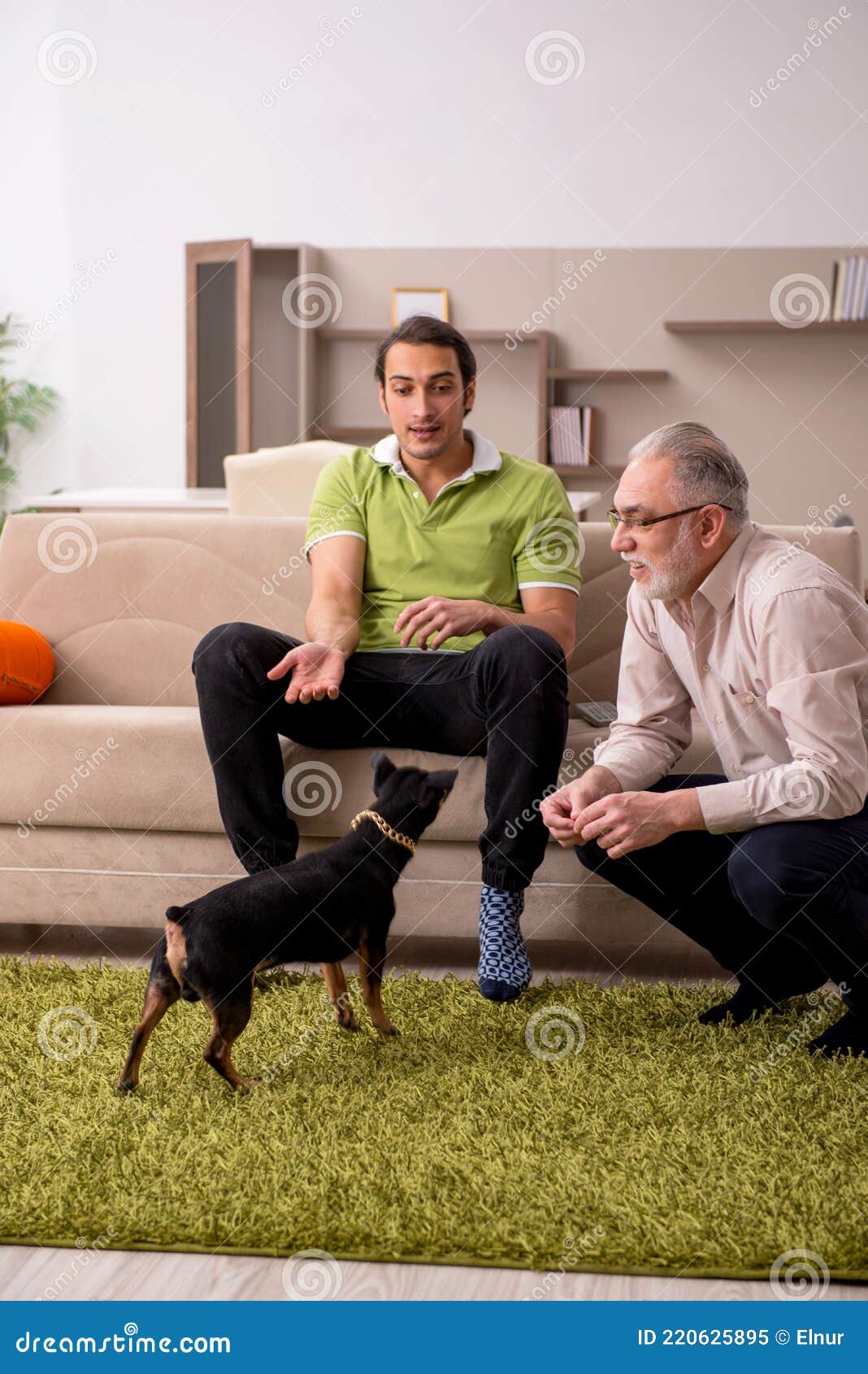 Two men with dog at home stock image. Image of companion - 220625895