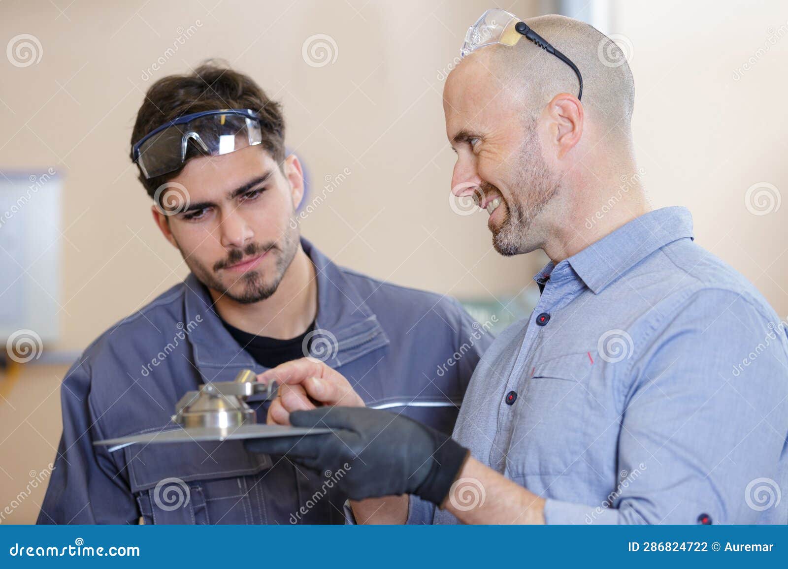 Two Men Doing Induction Hardening in Workshop Stock Photo - Image of ...
