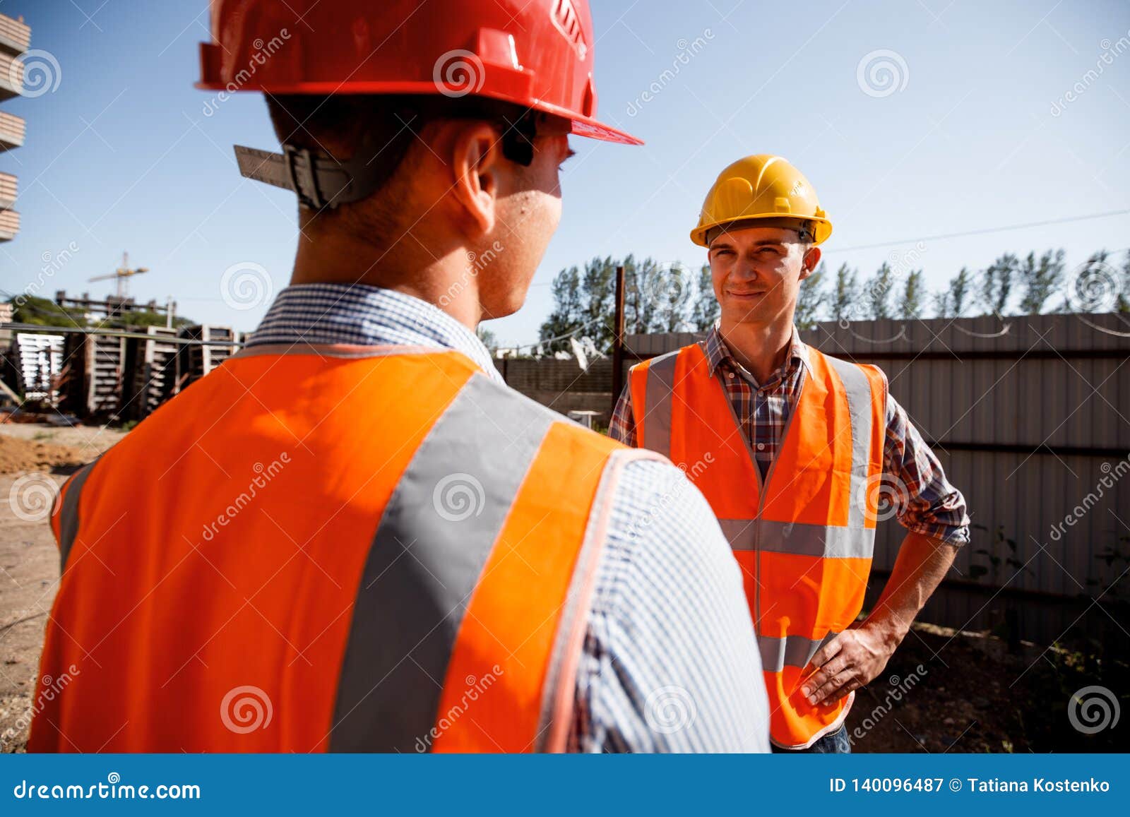 Two Men Dressed in Shirts, Orange Work Vests and Helmets Stock Image ...