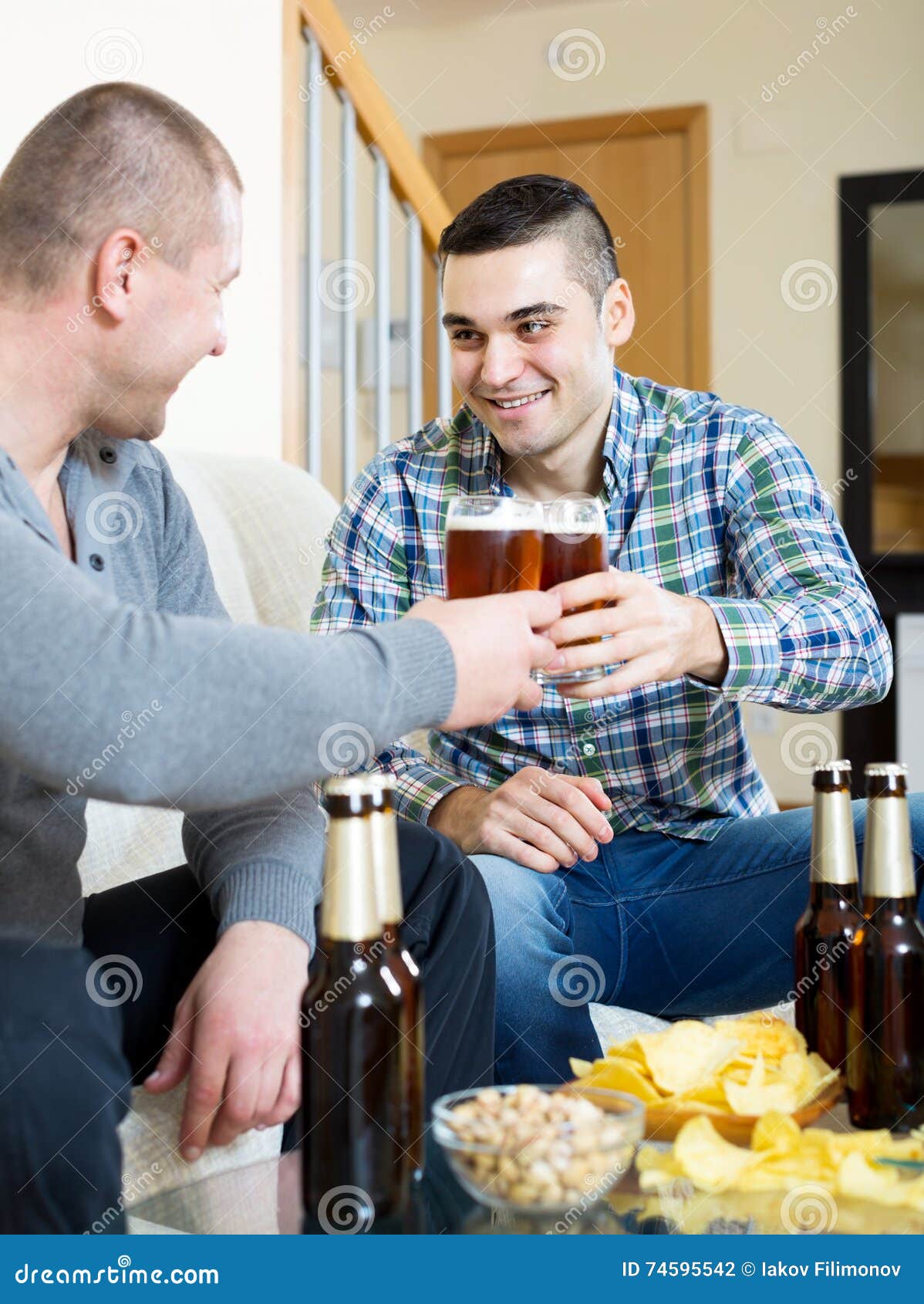 Two men drinking beer stock photo. Image of match, house - 74595542